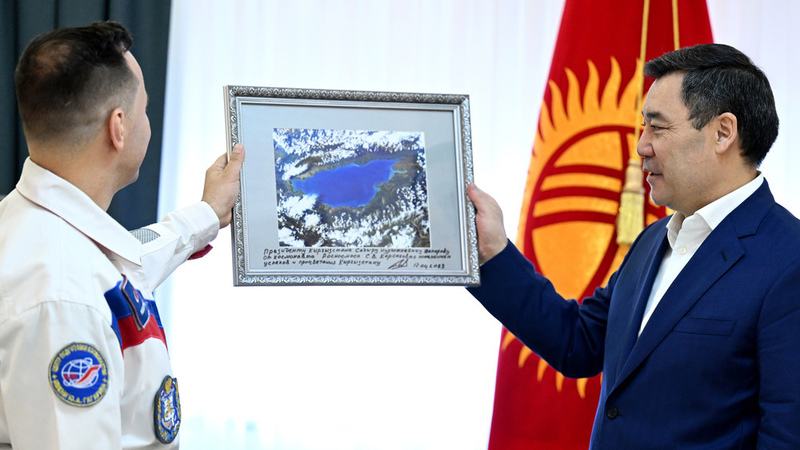Cosmonaut Sergey Korsakov presents flag of Kyrgyzstan with ...