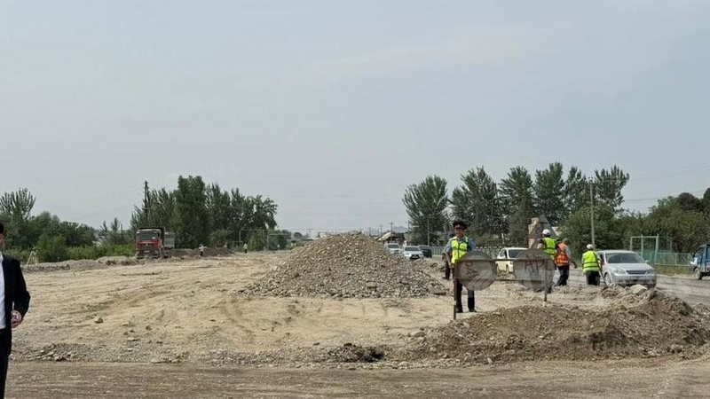 Four-lane road with bicycle lane under construction on Osh - Kara-Suu ...